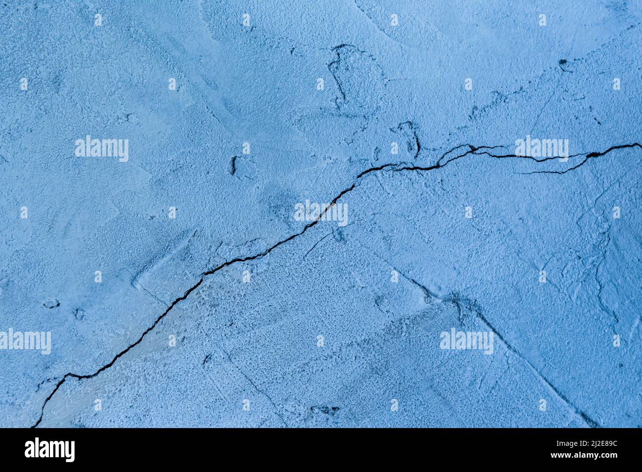 Crack on old dirty blue paint concrete wall of cement surface broken ...
