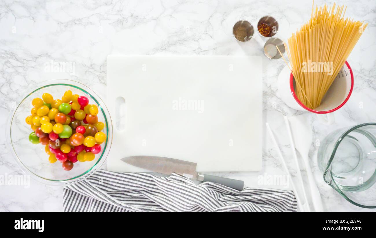 Flat lay. Step by step. Cutting vegetables on a white cutting board to ...