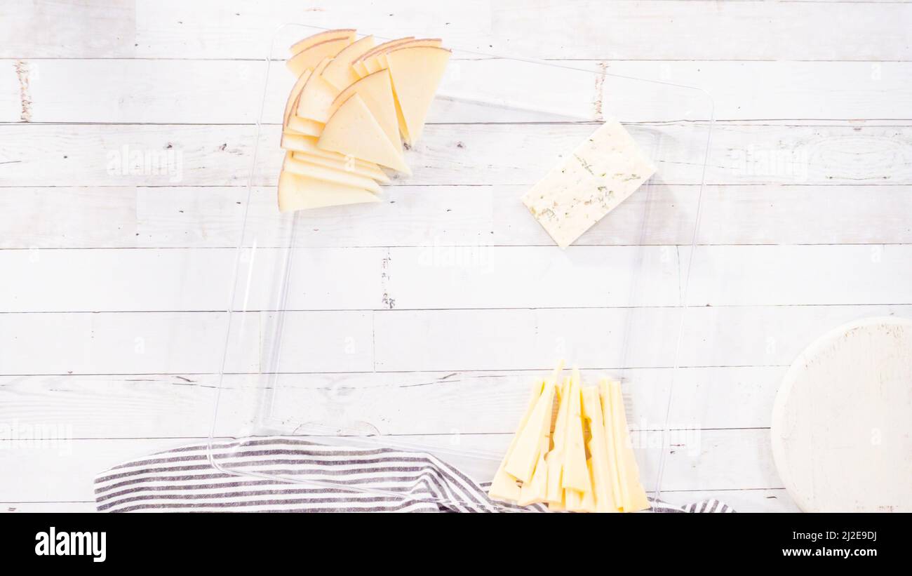 Flat lay. Step by step. Arranging cheese platter with fresh fruits ...