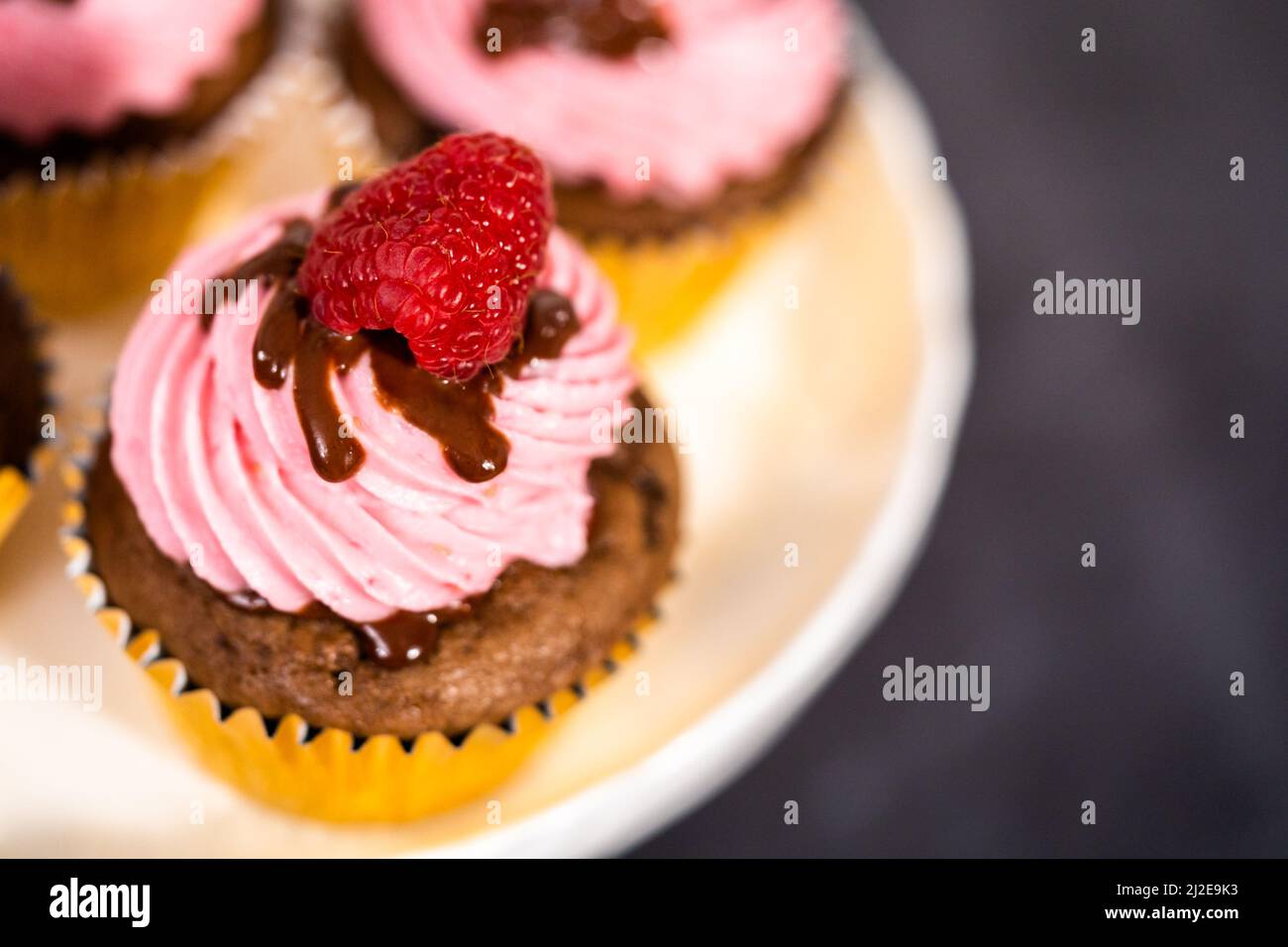 Gourmet chocolate raspberry cupcakes drizzled with chocolate ganache ...