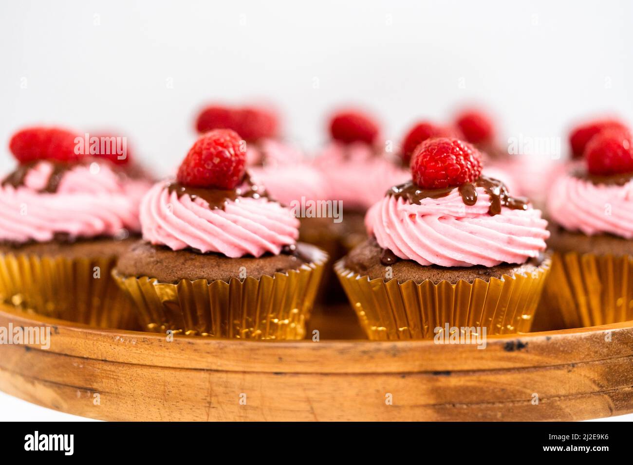 Gourmet chocolate raspberry cupcakes drizzled with chocolate ganache ...
