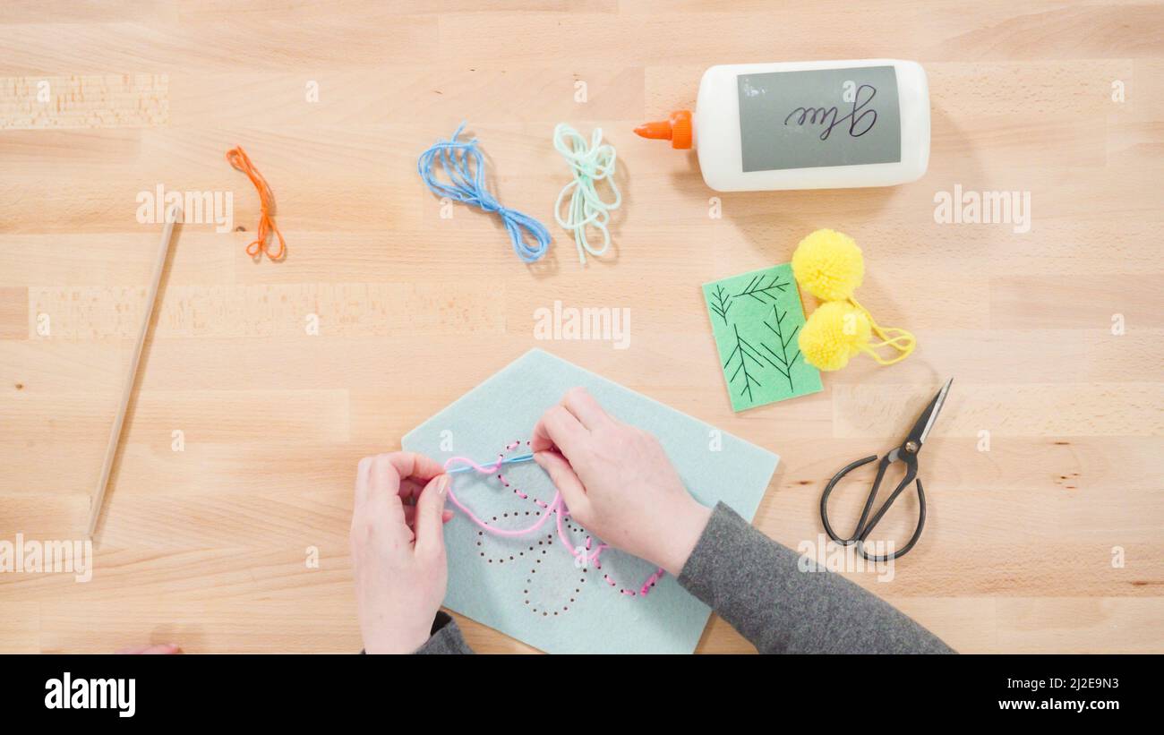 Mother teaching kids how to sew with simple sewing kit at the craft ...