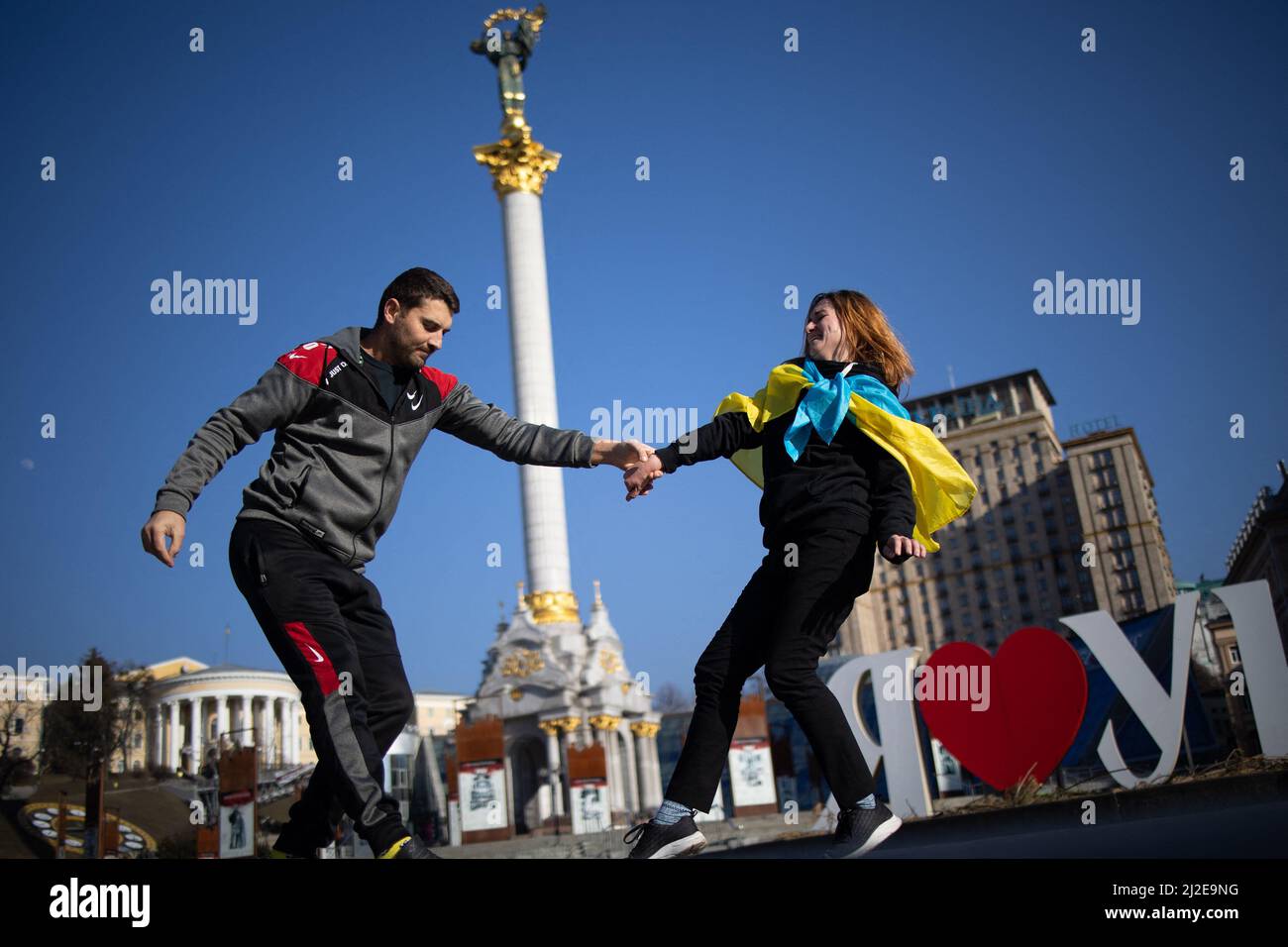 Man and Woman wearing an Ukrainian Flag dance on the Independence ...
