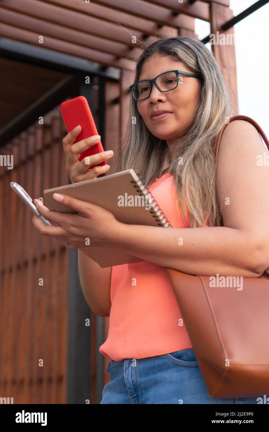 Lady outdoor device checking hi-res stock photography and images - Alamy