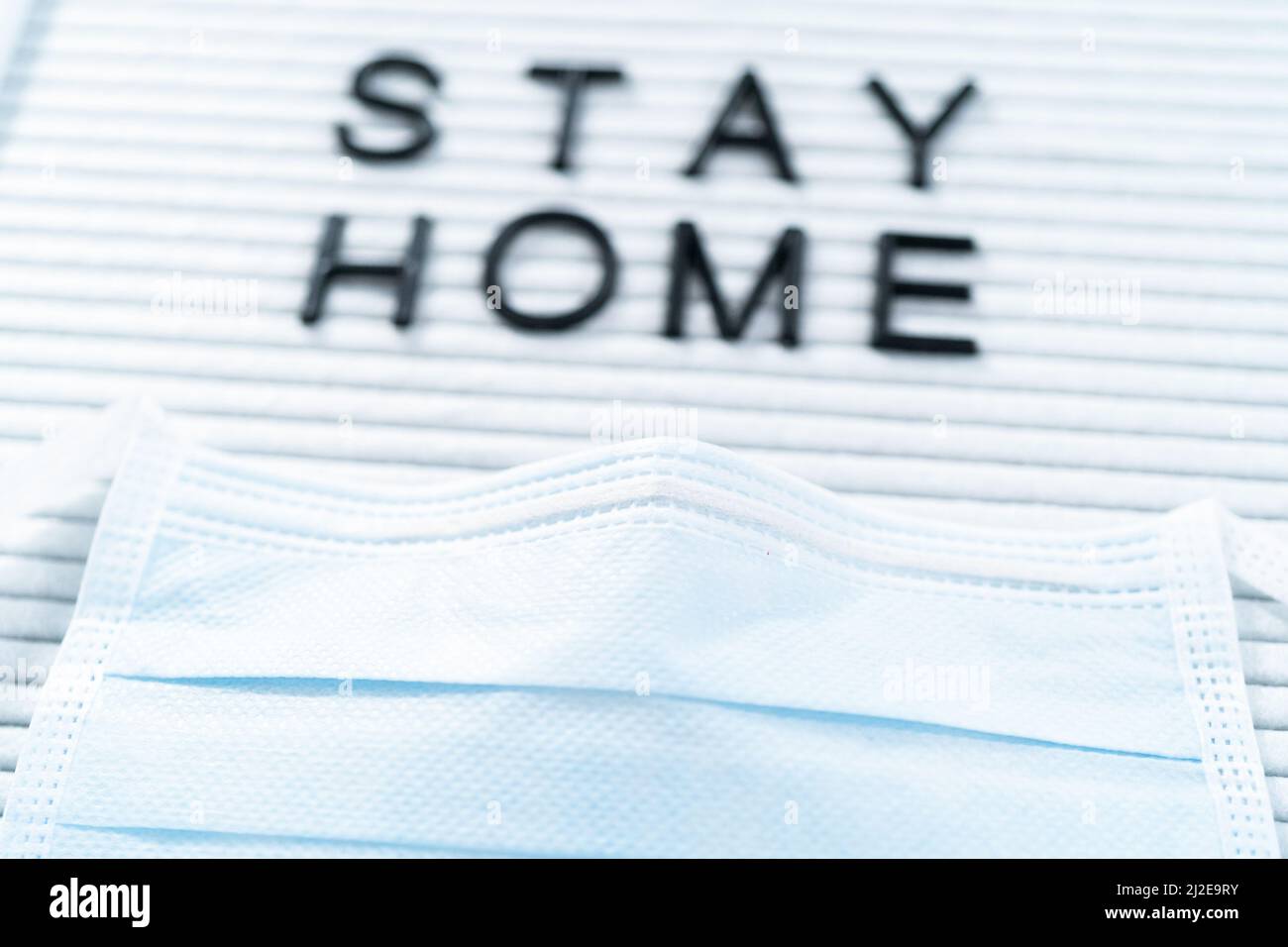 STAY HOME sign on message board with a blue medical mask Stock Photo ...