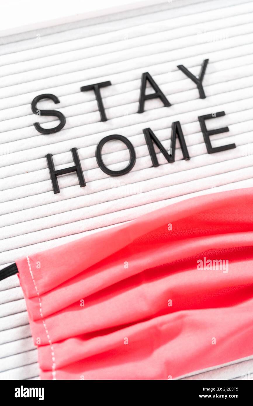 STAY HOME sign on message board with a homemade face mask Stock Photo ...