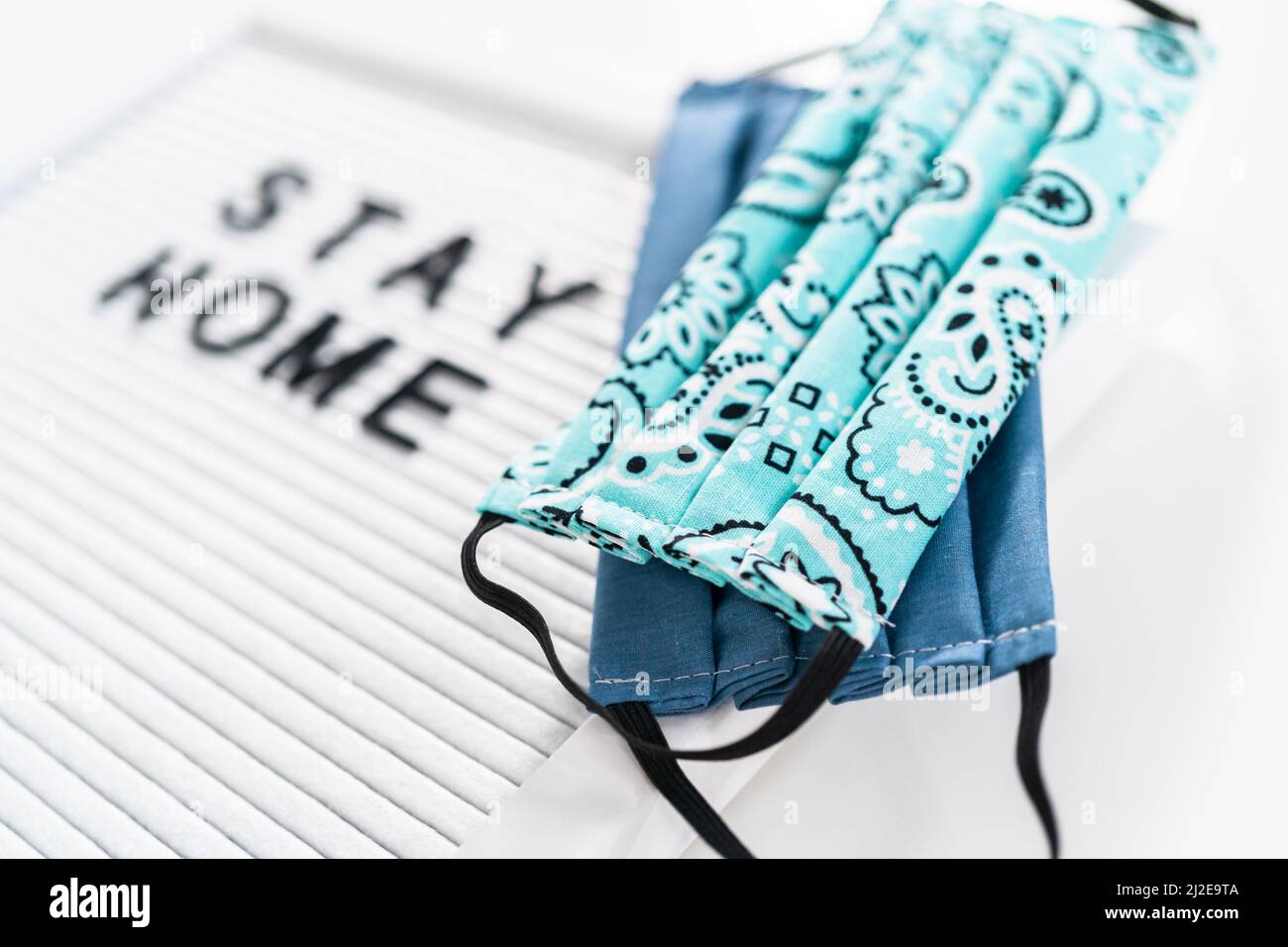 STAY HOME sign on message board with a homemade face mask Stock Photo ...