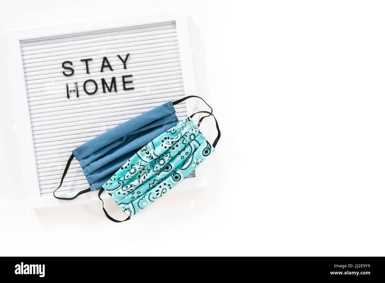 STAY HOME sign on message board with a homemade face mask Stock Photo ...