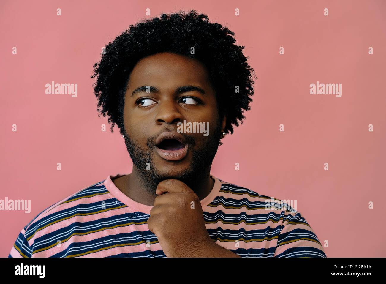 african american man thinking in the studio over pink background male ...