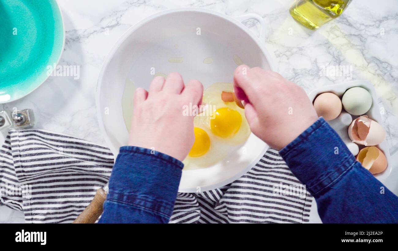 Flat lay. Frying farm fresh eggs in a white skillet Stock Photo - Alamy