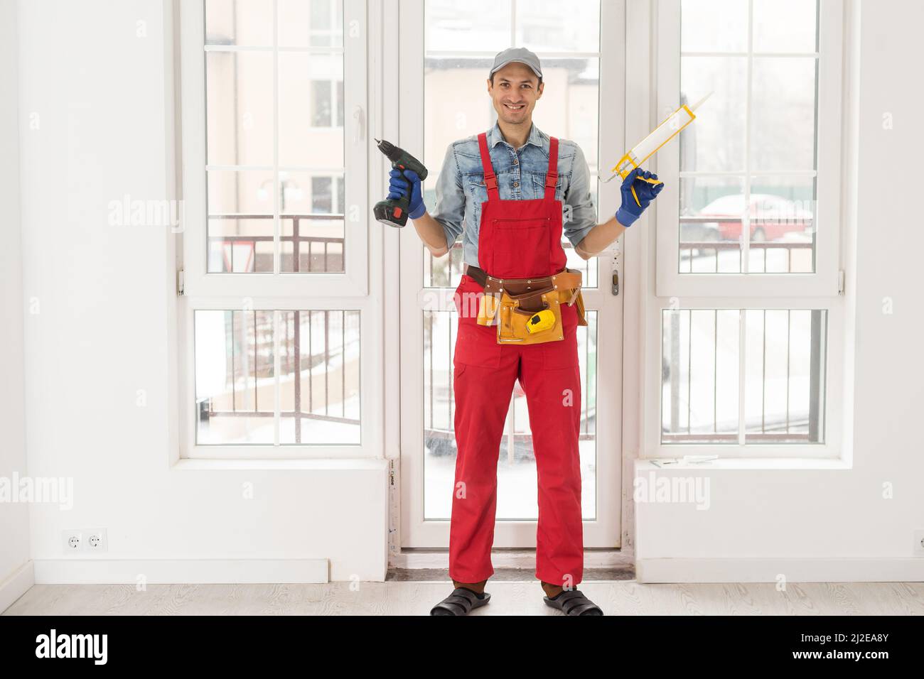 Construction worker installing window in house. Handyman fixing the ...