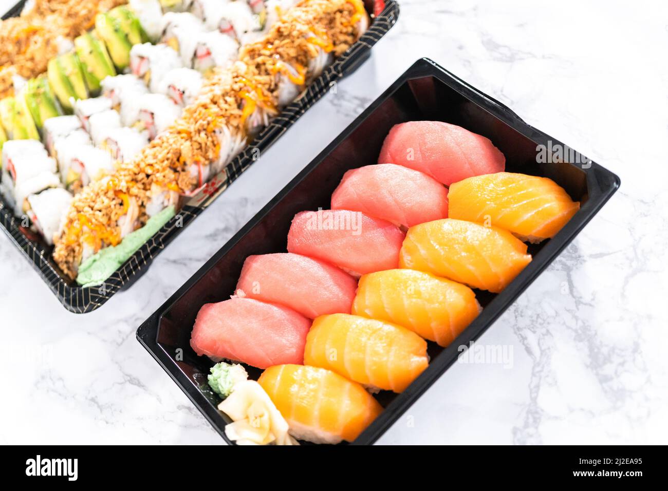 Pre-packaged variety of sushi and sushi rolls in a plastic tray Stock ...