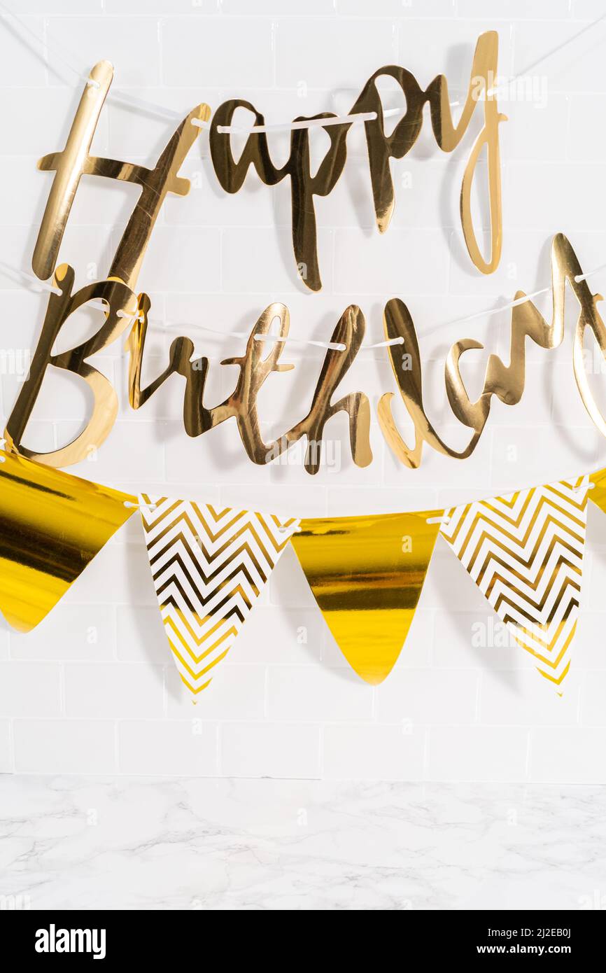 Paper Happy Birthday gold paper banner in the kitchen Stock Photo - Alamy