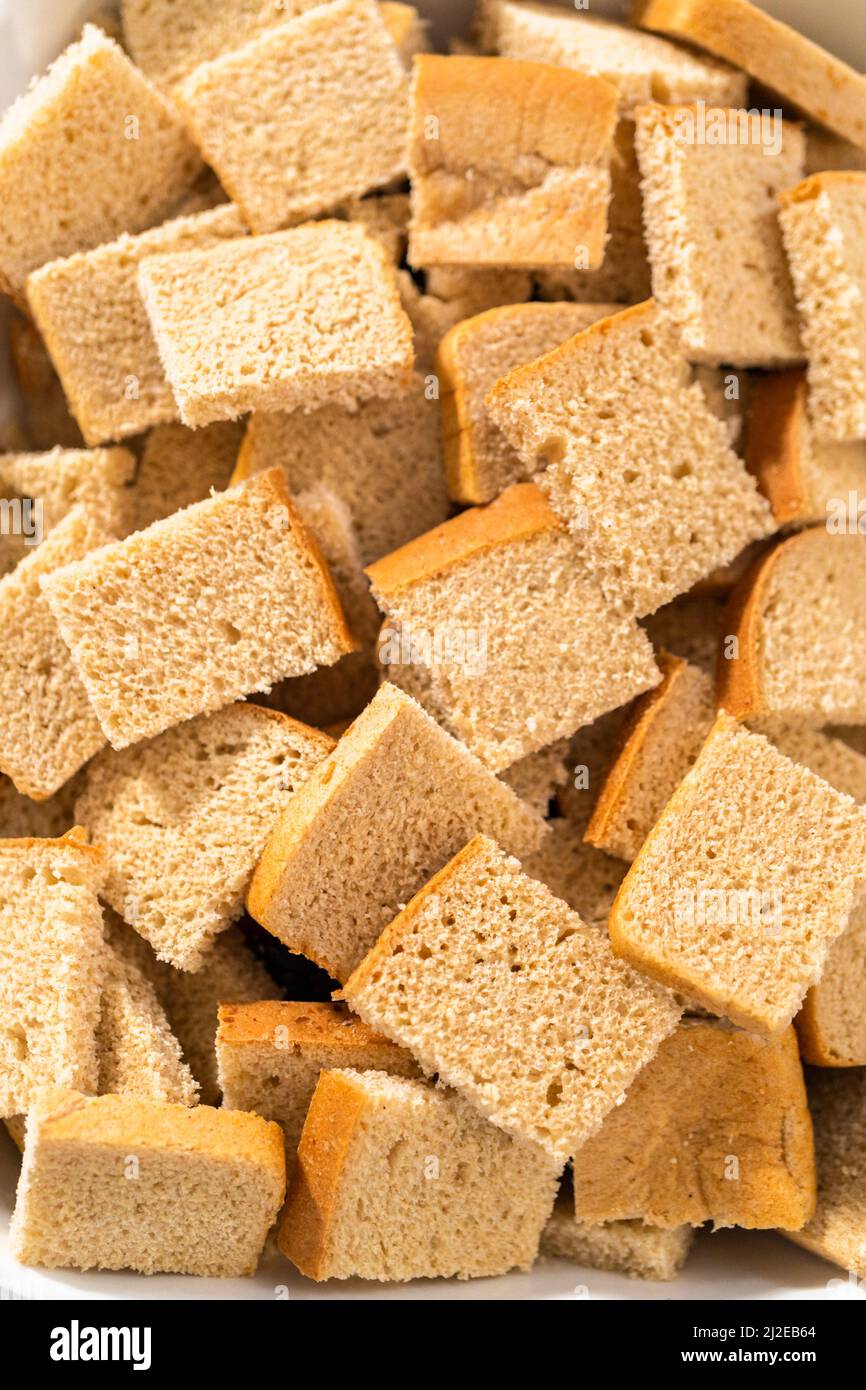 Baking bread pudding with raising and almond slivers in a white ...