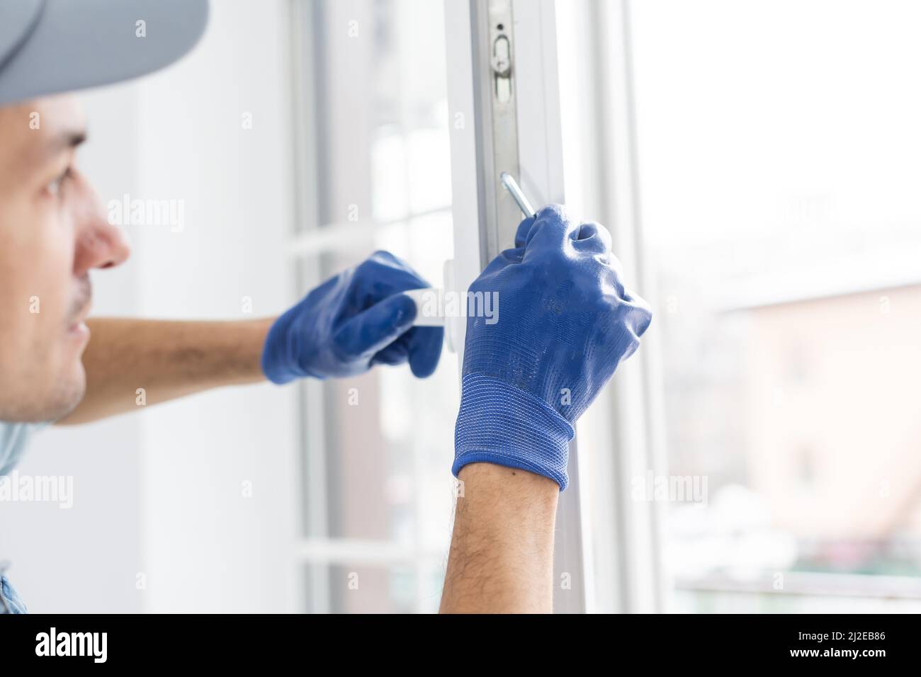 The worker installing and checking window in the house Stock Photo - Alamy