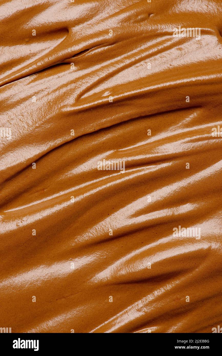 Texture of brown whipped chocolate, caramel or coffee cream, top view ...