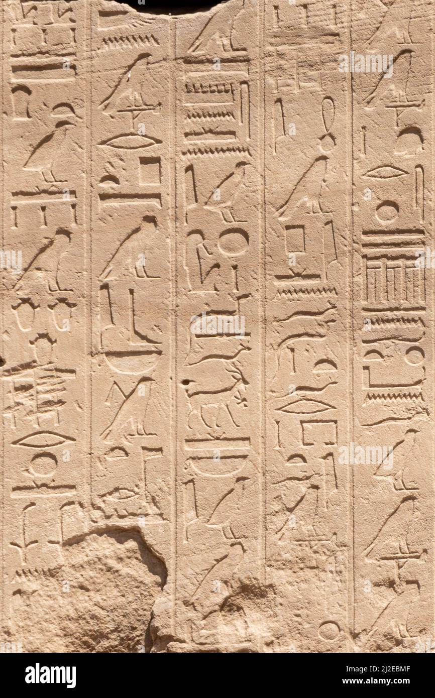 Ancient Egyptian murals and hieroglyphs on the stone walls of the ...