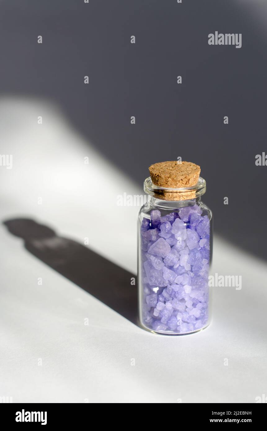 Sea salt with the smell of lavender in a bottle on a white background ...