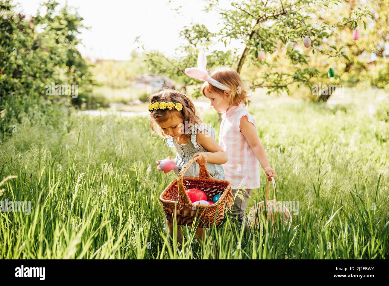 Easter egg hunt. Group Of Children Wearing Bunny Ears Running To Pick ...
