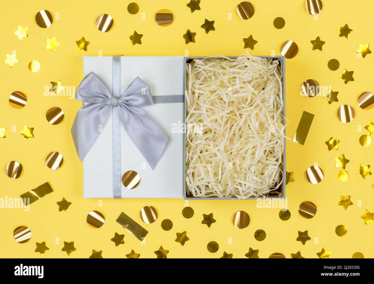 Open gift box mock up. Gift box with filler on festive yellow ...