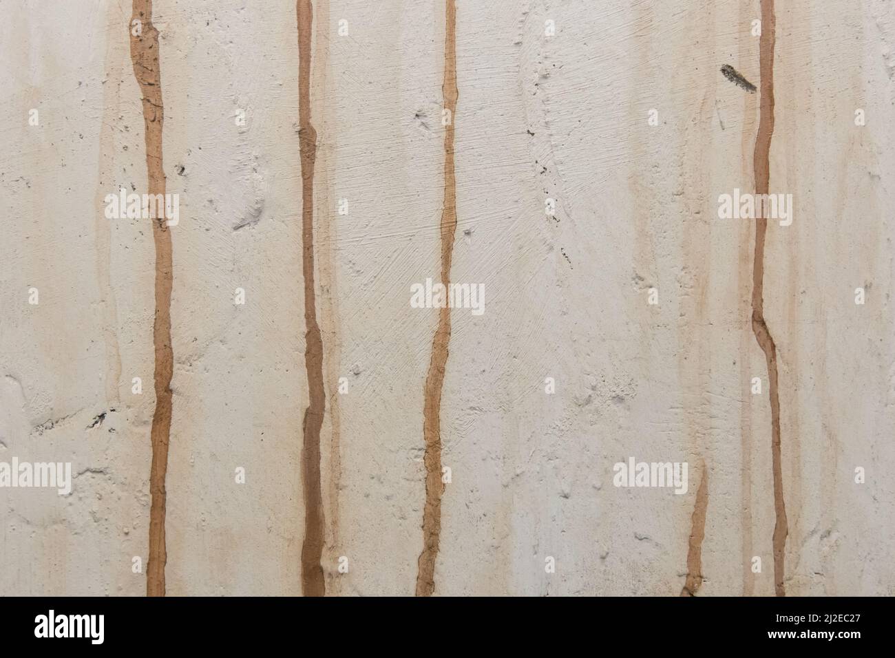 Old dirty concrete white wall with streaks of rusty water weathered ...