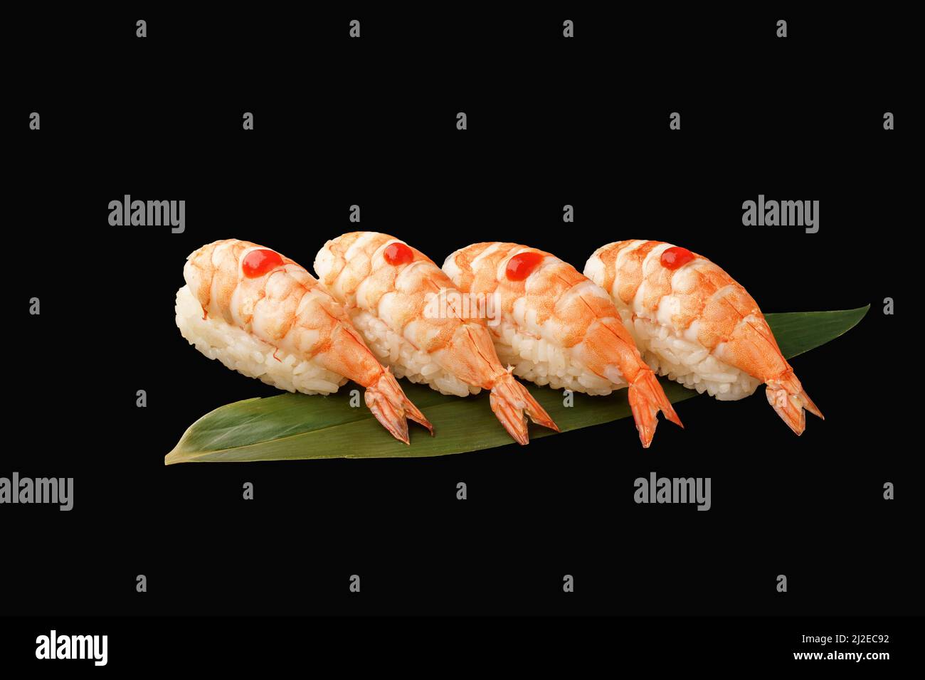 Nigiri sushi tiger shrimp, sriracha sauce, chives, banana leaf ...