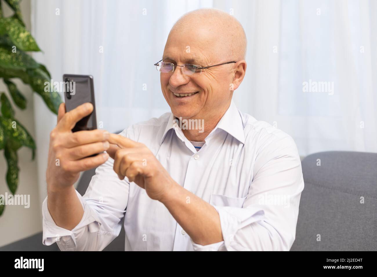 Closeup portrait headshot elderly man with glasses having seeing cell ...