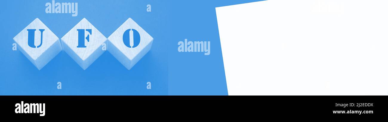 The word UFO written on wooden cubes isolated on a black background ...