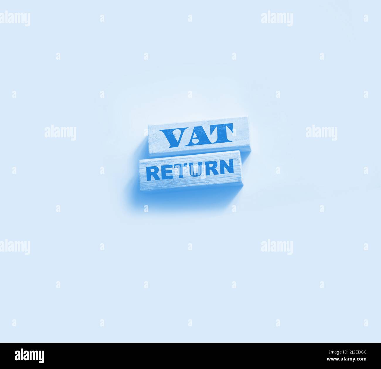 VAT return text Value Added Tax return on wooden blocks on pink ...