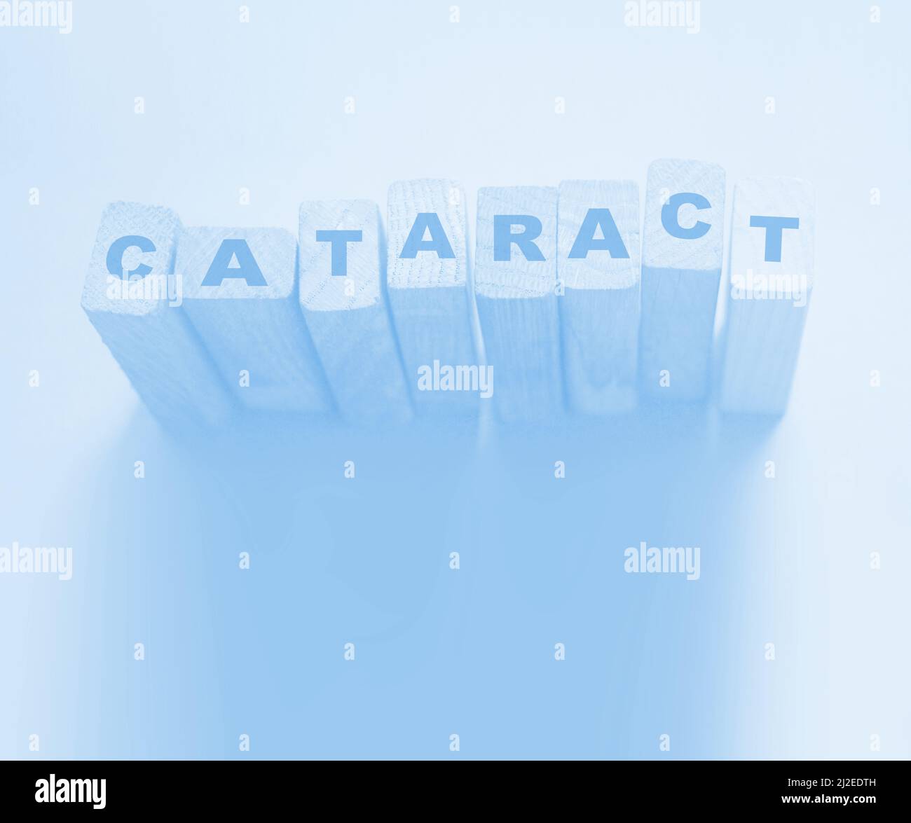Cataract word made with building blocks on light cyan. Eye healthcare ...