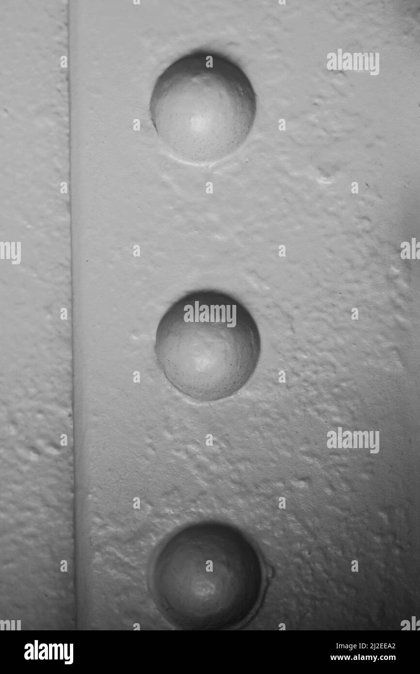 A solid structural steel bolted connection with lots of bolts and ...