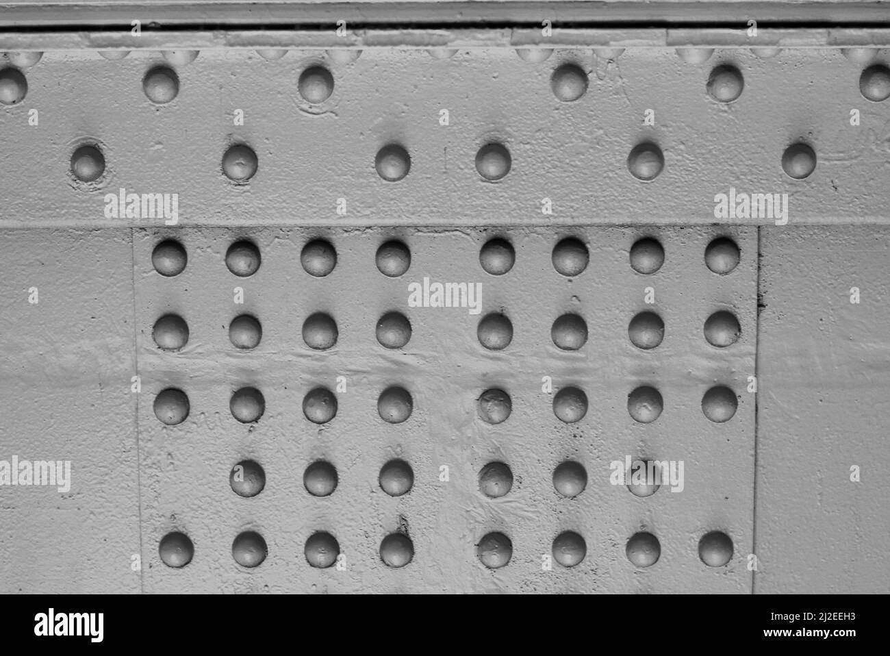 A solid structural steel bolted connection with lots of bolts and ...