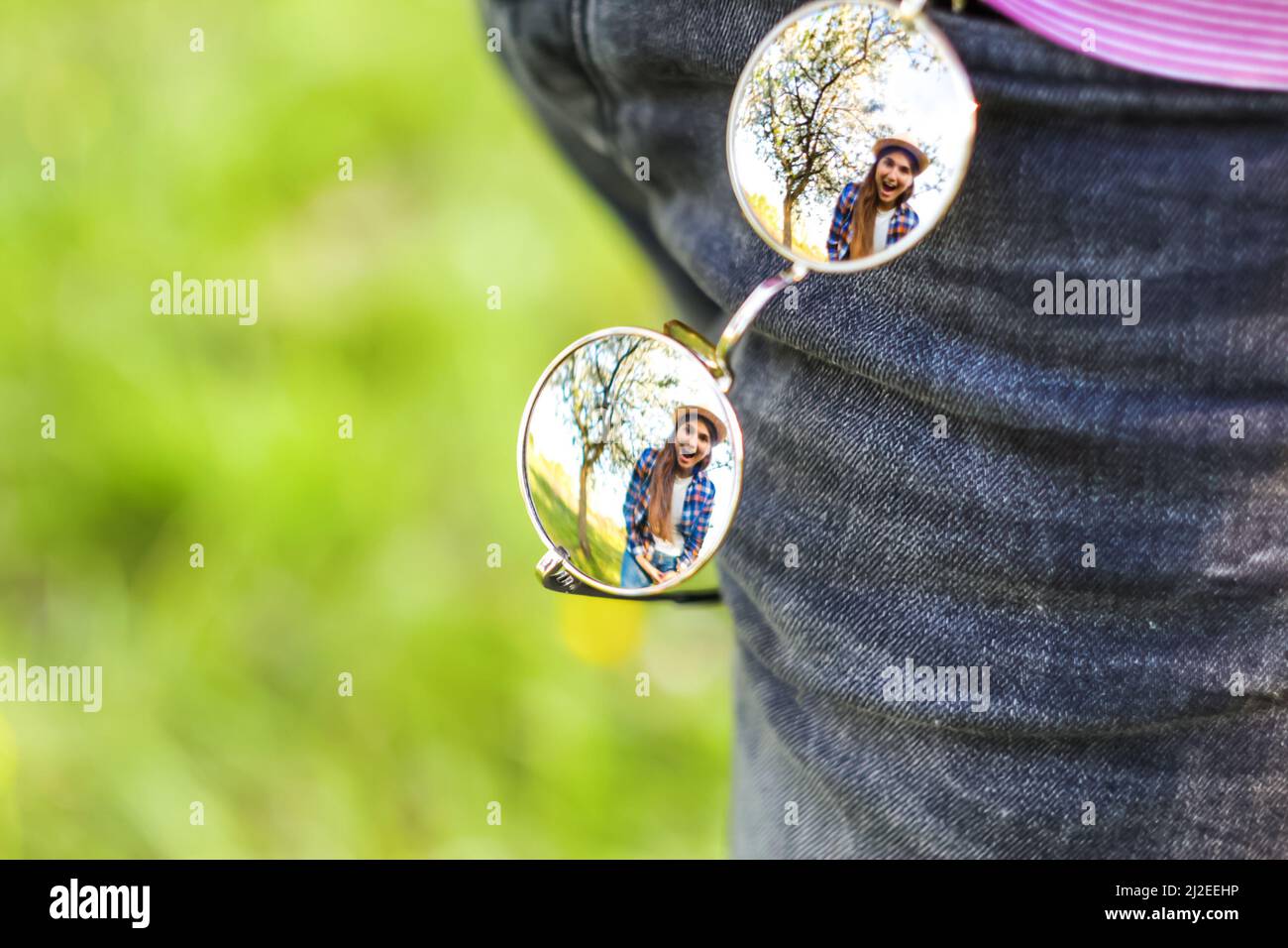 Defocus circle sunglasses. Reflection on mirror. Young funny woman ...