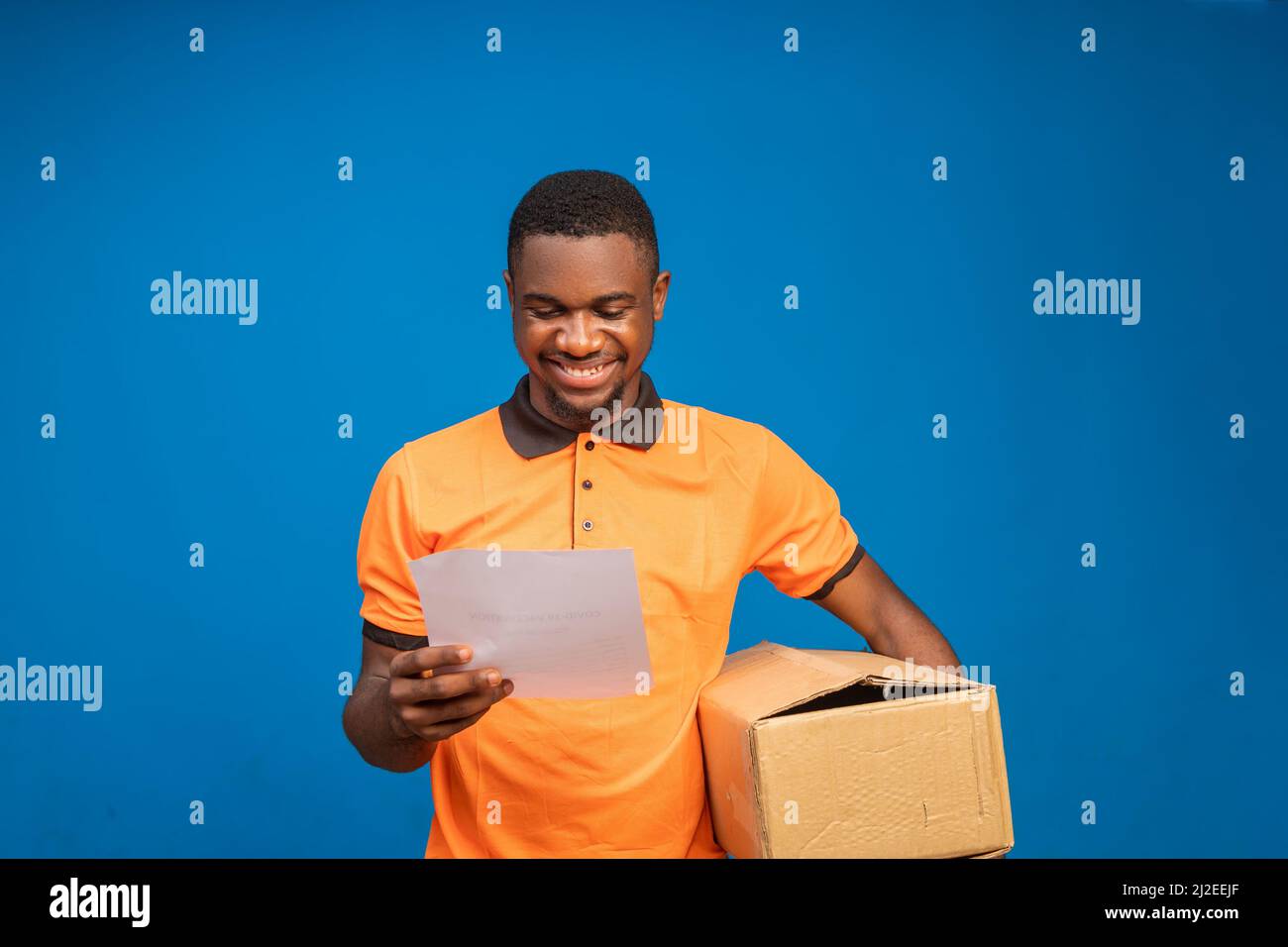 african american delivery man carrying parcel and presenting receiving ...