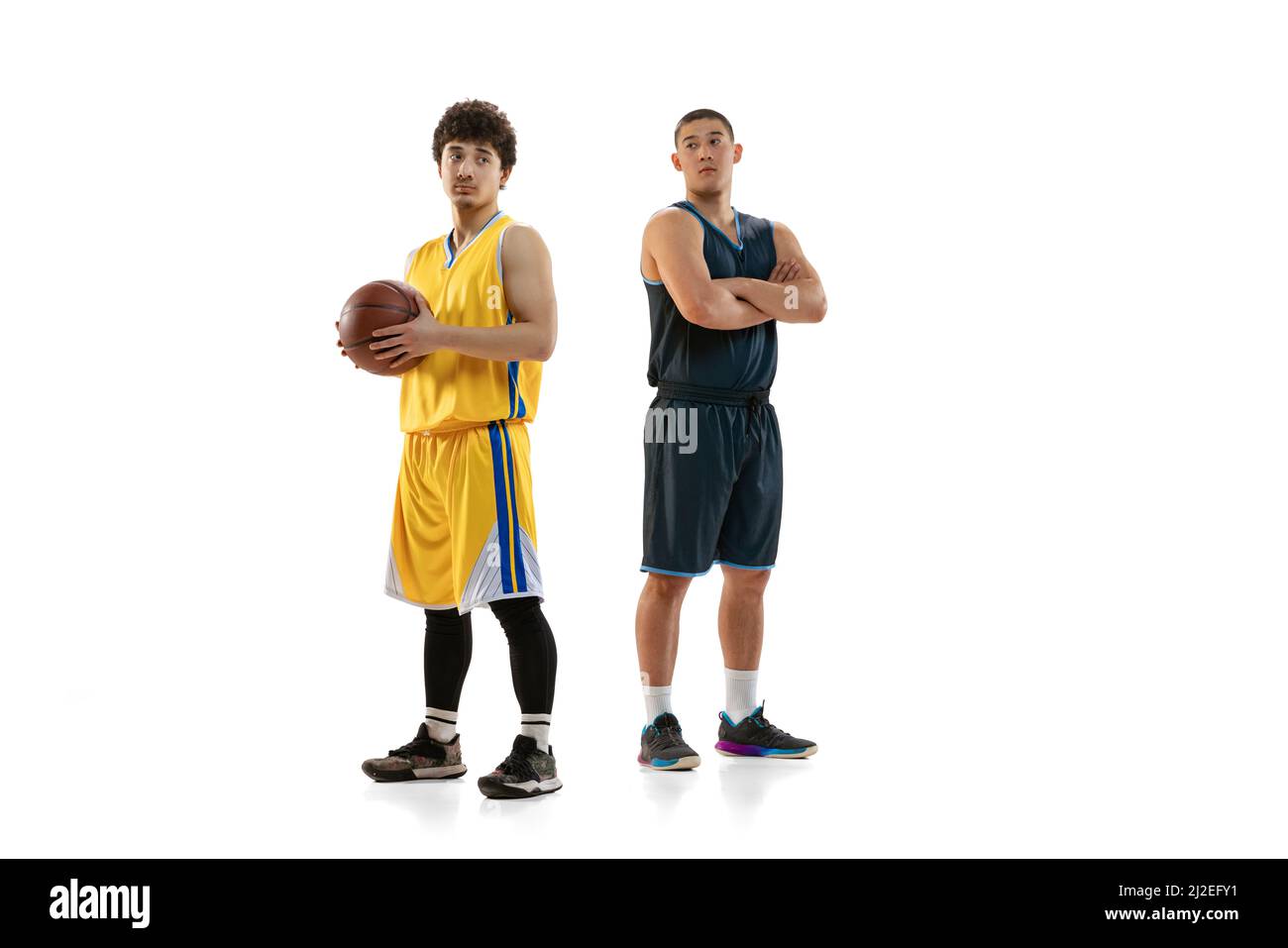 Portrait of two young basketball players posing isolated on white ...