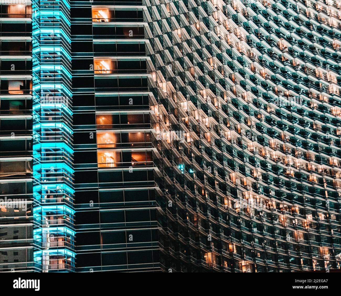A closeup of a modern skyscraper illuminated with neon lights Stock ...