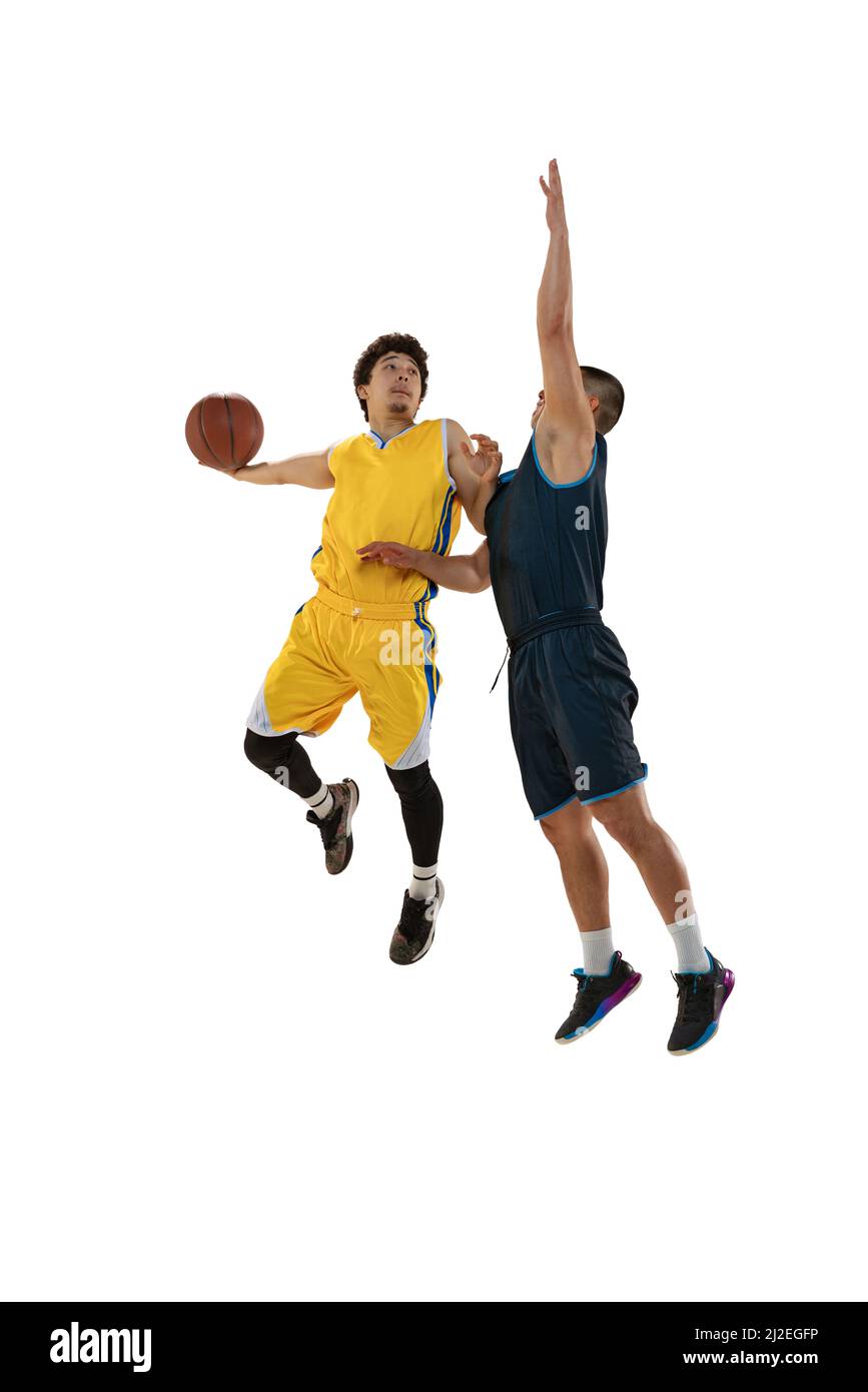 Full-length portrait of two young basketball players jumping with ball ...