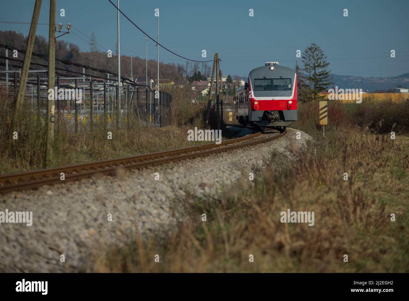 Older type diesel railcar is driving through the fields in the spring ...