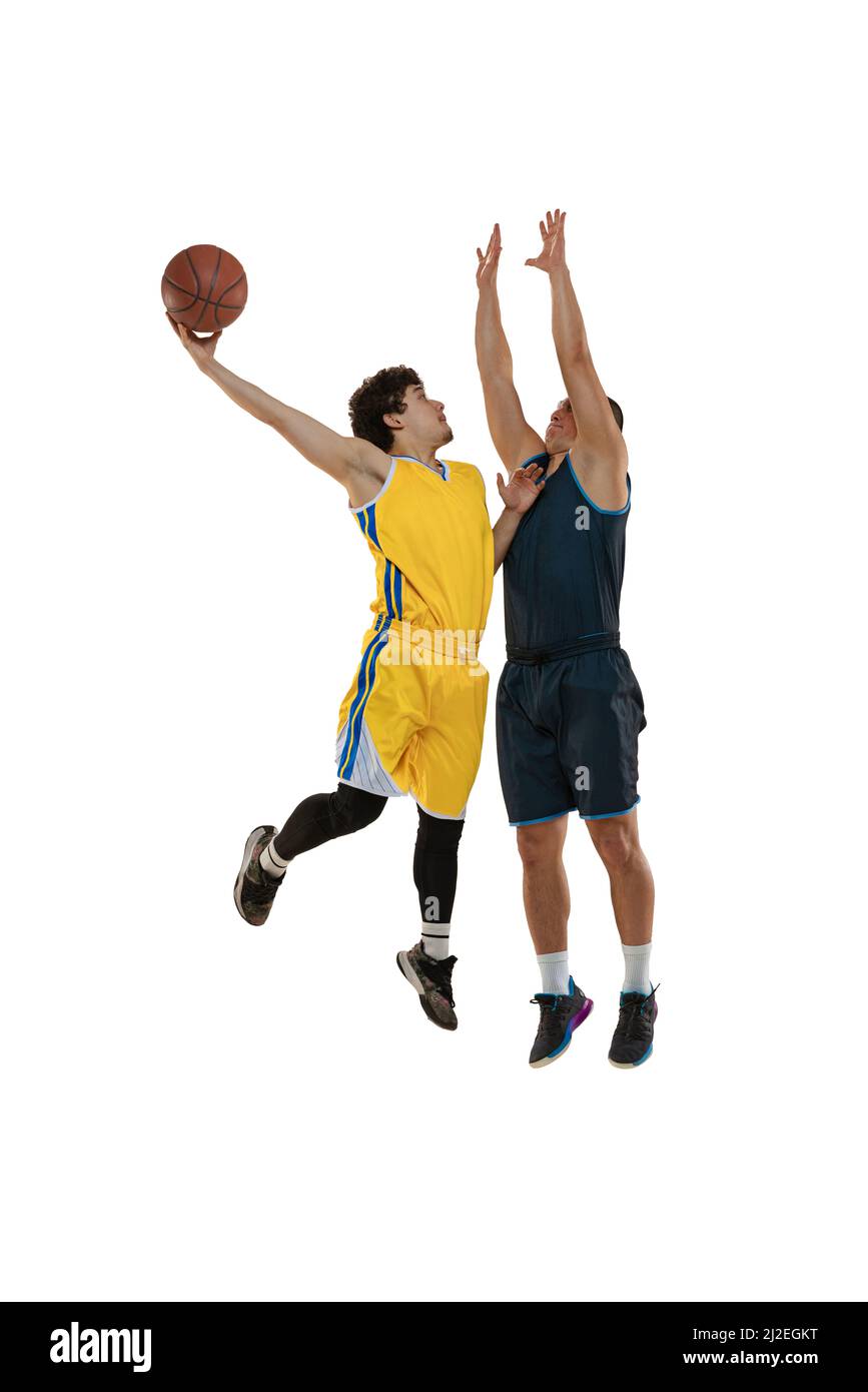 Dynamic portrait of two young basketball players jumping with ball ...