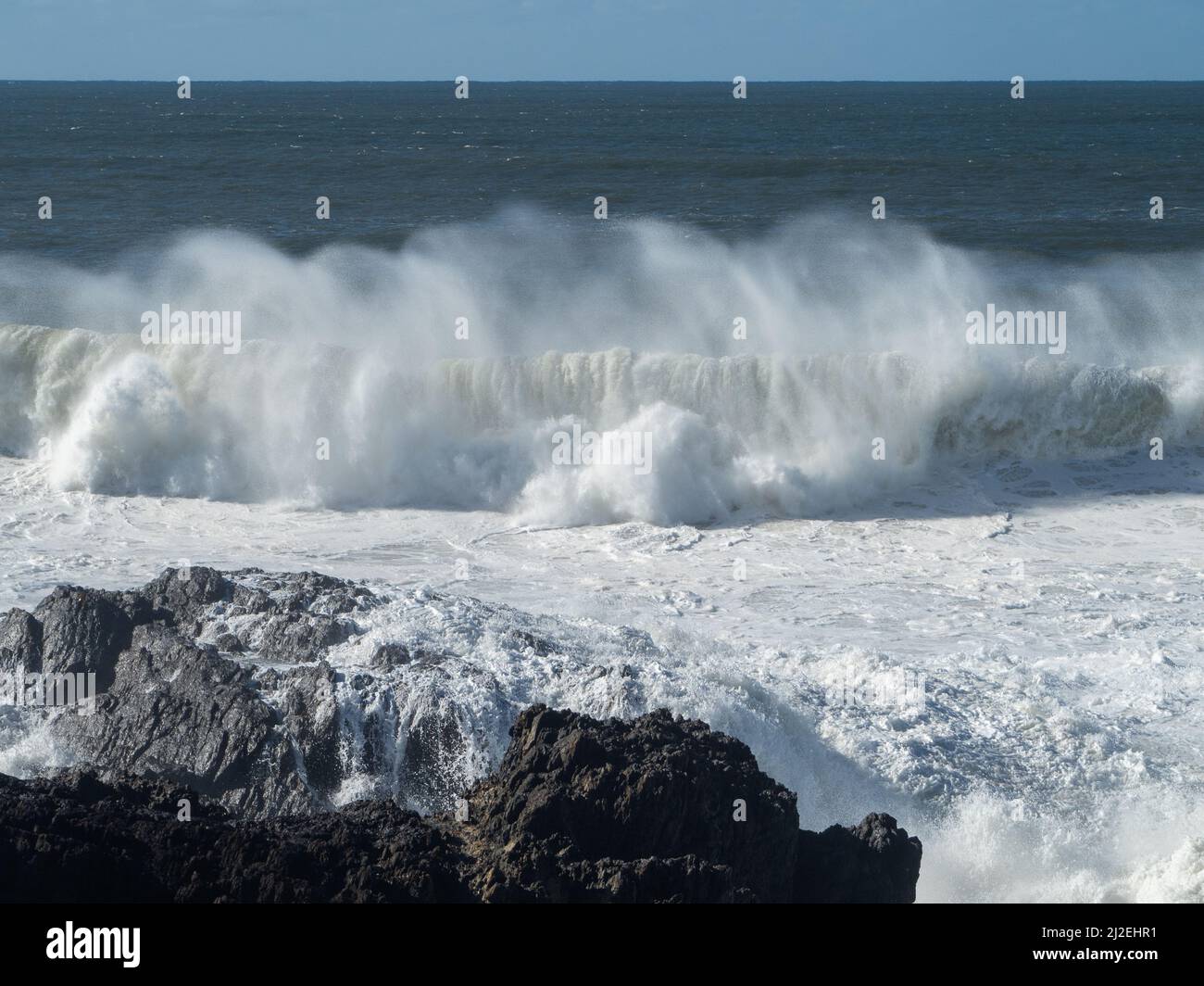 Swirling sea spray flying from wild sea waves breaking, crashing and ...