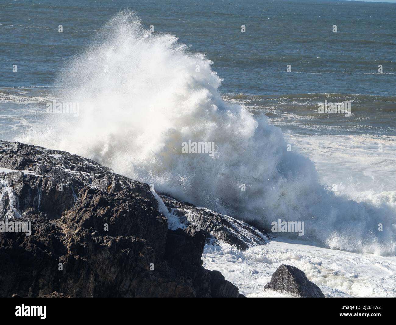 Wild sea waves crashing and splashing, water cascading over rocks ...