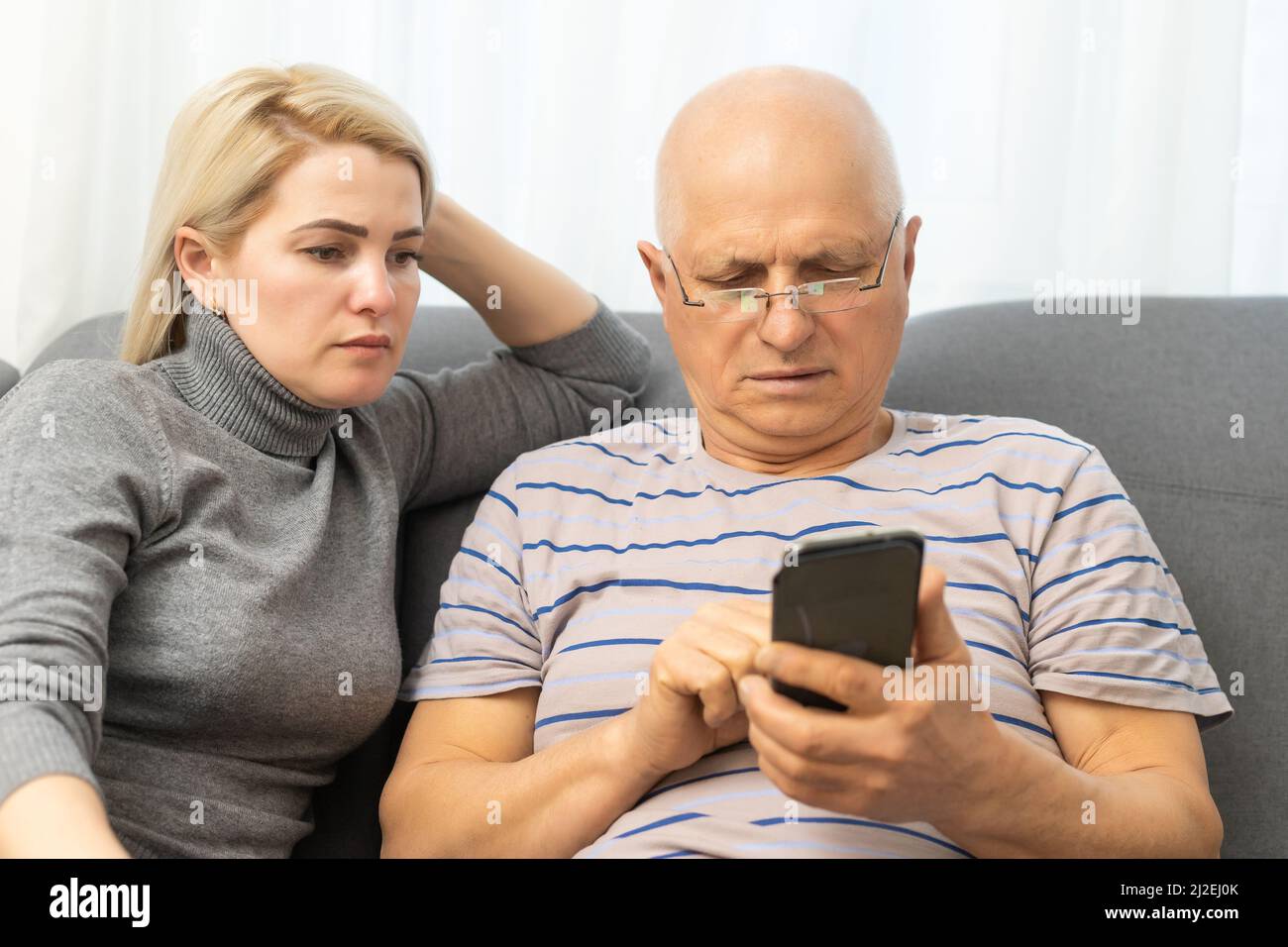 Happy father and daughter looking at a mobile phone isolated on white ...