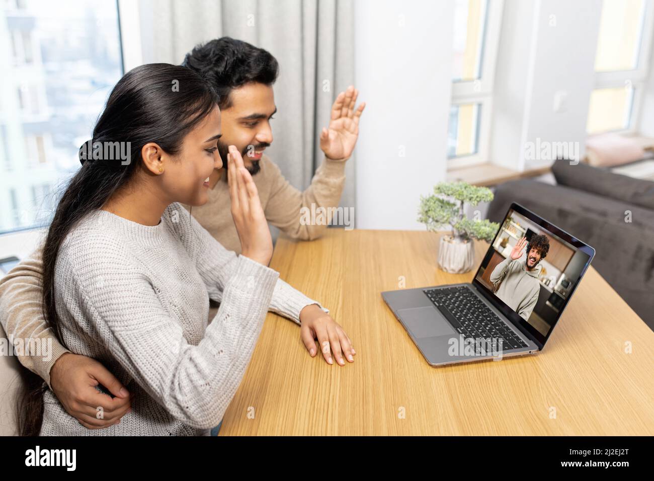 Interracial couple talking online, having video meeting on the laptop ...