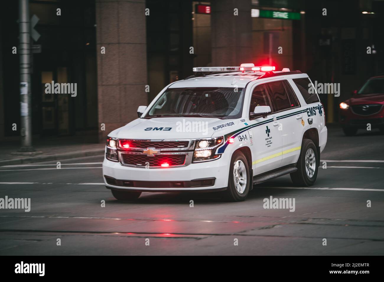 An EMS vehicle with emergency equipment activated responds to a call ...
