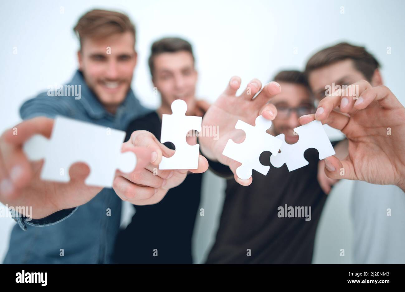 group of young people with puzzle pieces Stock Photo - Alamy