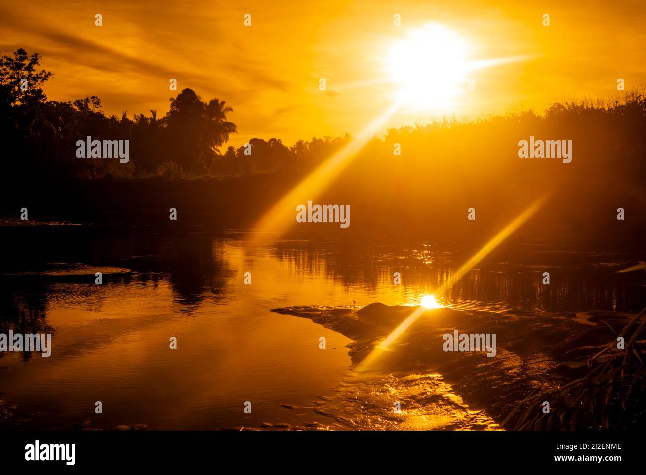 A yellow-filtered photo of sunset on a tranquil river Stock Photo - Alamy