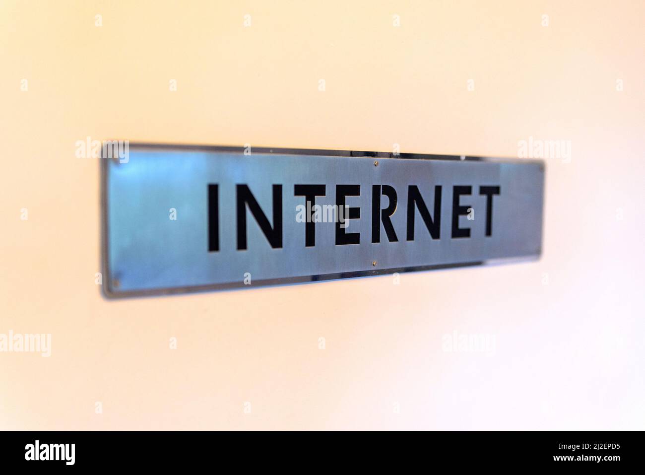 Steel plate Internet sign fixing on the wall Stock Photo - Alamy