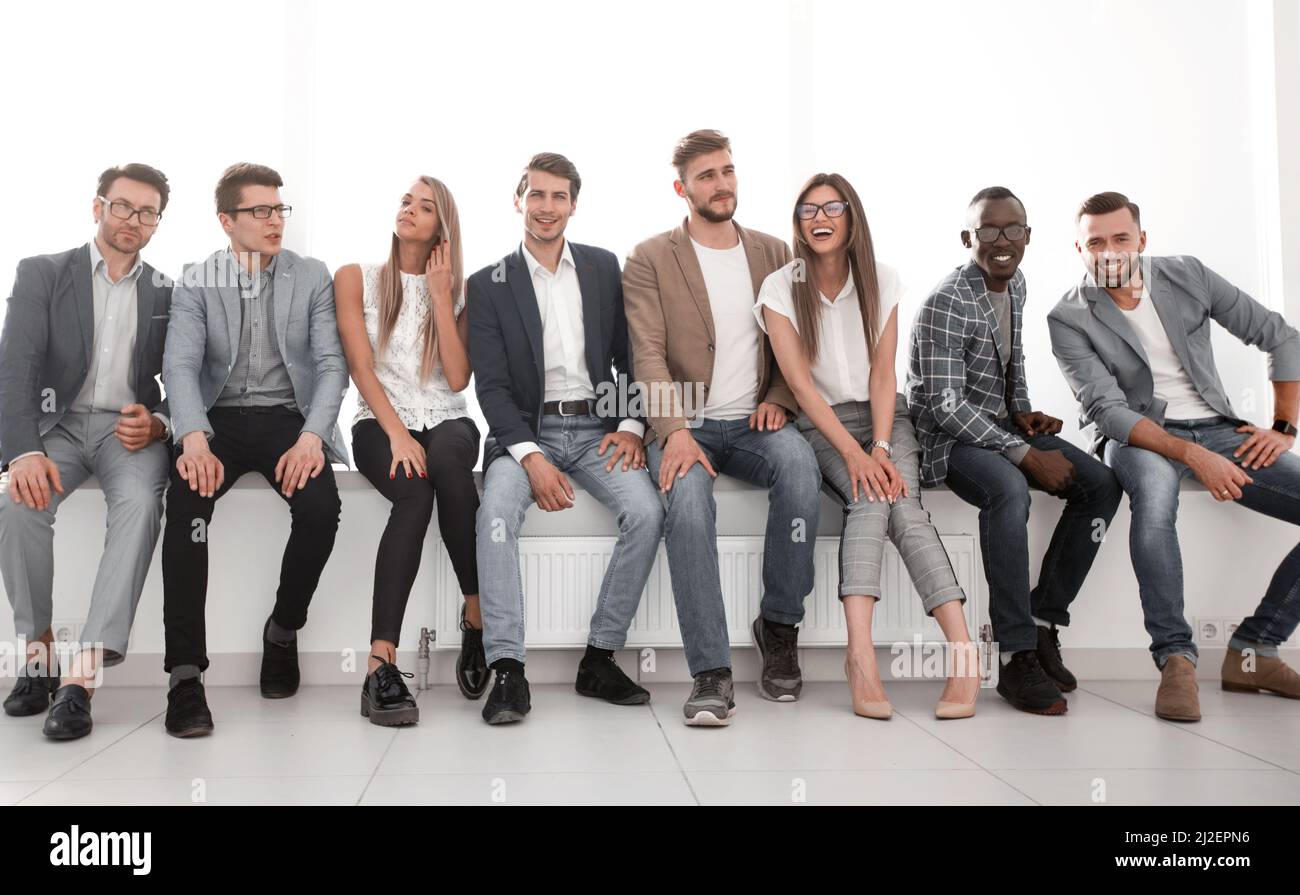 young people are waiting for an interview, sitting in the office lobby ...