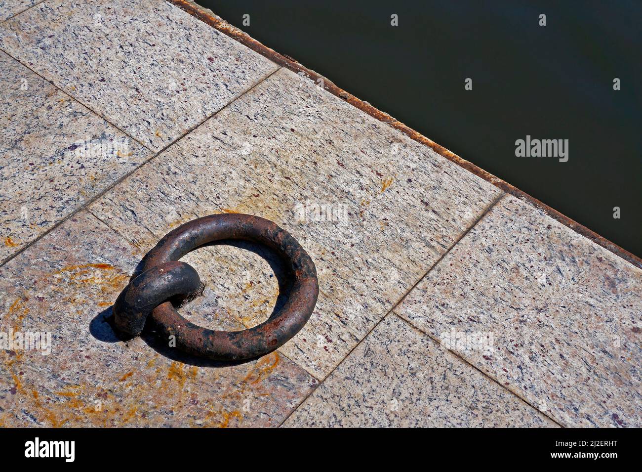 Old iron mooring ring on a stone dock Stock Photo - Alamy
