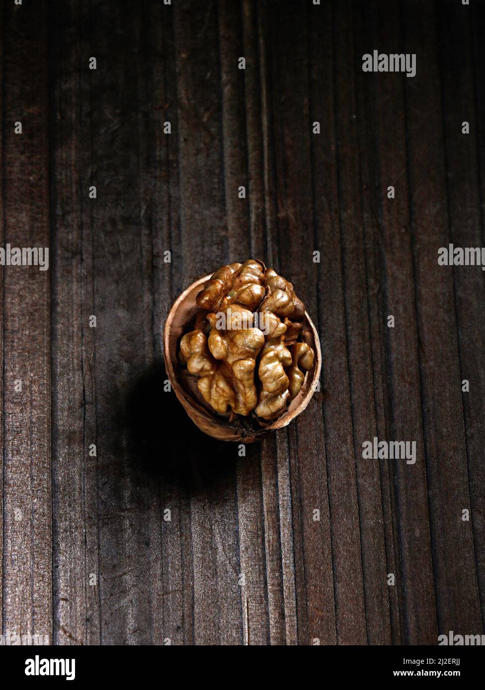 A top view of fresh open walnut on wooden table Stock Photo - Alamy